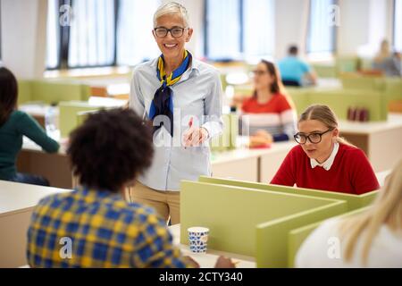 professor talking to female student in corridor Stock Photo - Alamy