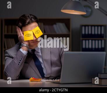 Businessman staying late to sort out priorities Stock Photo - Alamy