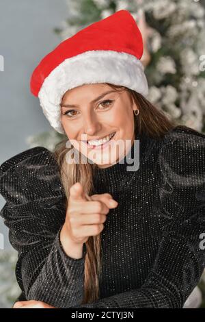 Young beautiful woman at home pointing with hand and finger up with ...