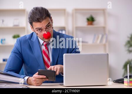 Funny employee clown working in the office room Stock Photo - Alamy