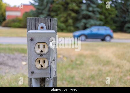 Car Block heater in office parking lot Stock Photo - Alamy
