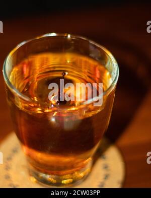 drops of red liquid in glass beaker Stock Photo - Alamy