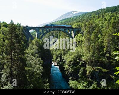 Train crossing Kylling Bridge on the Rauma Line, Romsdalen, Norway ...