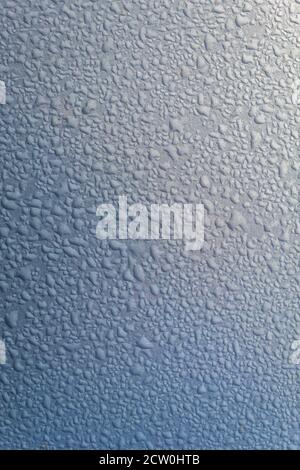 Light blue liquid drops of paint color flow down on isolated white ...