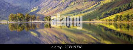 The famous Char Hut and Sentinel Trees at Buttermere are reflected in ...