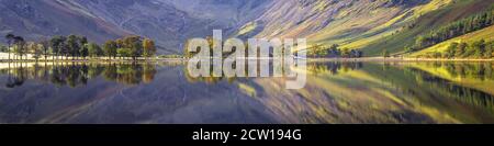 The famous Char Hut and Sentinel Trees at Buttermere are reflected in ...