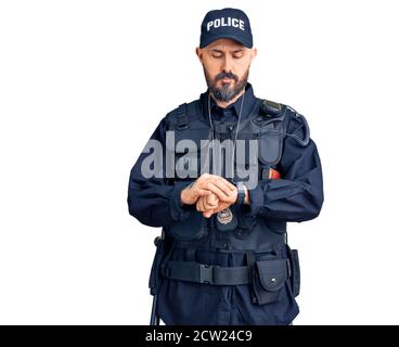Handsome hispanic man wearing police uniform showing and pointing up ...