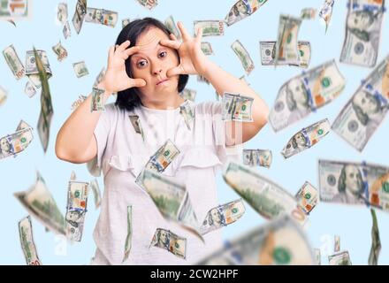 Woman with down syndrome wearing sleeping mask hugging pillow worried ...