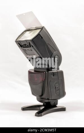 Oblique view of a black unbranded external flash unit for DSLR camera ...
