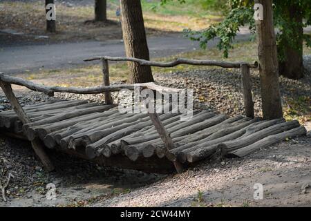 Close-up of old decrepit trees and wooden stakes in an old residential ...