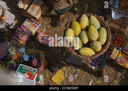 Pakistani farmers busy in their trucks loaded with watermelon at a ...