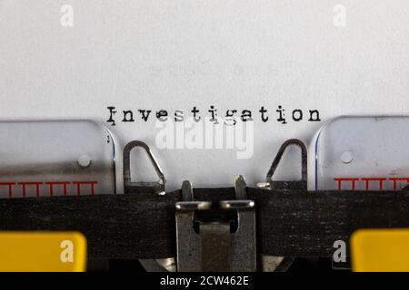 Investigation text on typewriter Stock Photo - Alamy