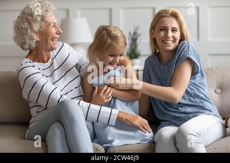 Grandma tickling granddaughter Stock Photo - Alamy