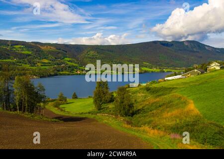 Farmhouses at Slidrefjord lake shore seen from E16-European route from ...