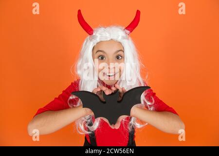 halloween devil child in imp horns hold pumpkin for jack o lantern ...