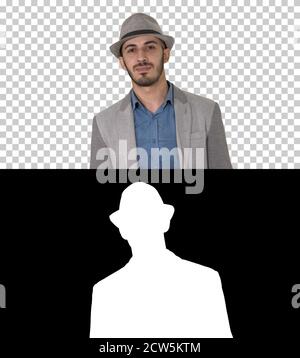 Handsome man swiping pages on tablet and smiling to camera on gradient ...