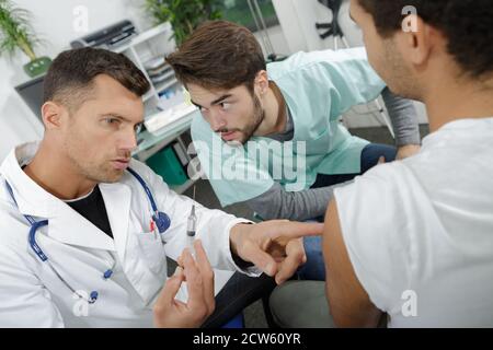 young nurse learning to inject a patient Stock Photo - Alamy