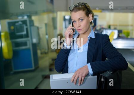 woman warehouse worker or supervisor with smartphone Stock Photo - Alamy