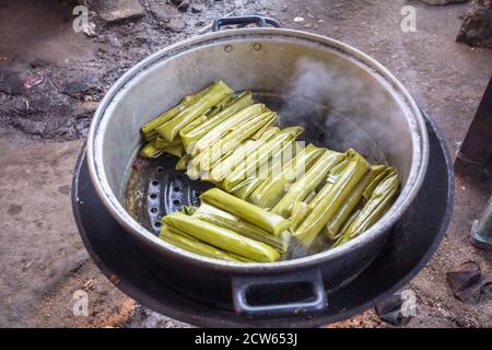 Traditional Filipino rice cakes called suman, wrapped in young coconut ...