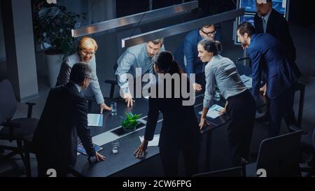 Colleagues lean on the conference table and discuss business, app UI ...