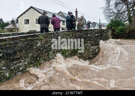 Spectators gather on the old 17c bridge over the River Lugg in ...