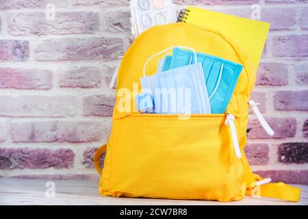 Student school bag pack with sanitizer, a face mask, pencils, books and ...