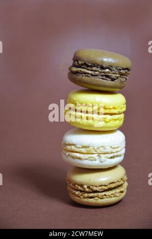 Row of different macaroons on a yellow pink background. Creative layout ...