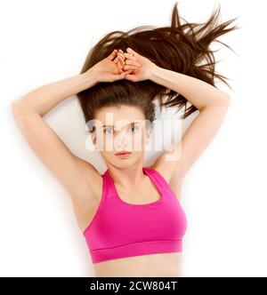 Young woman laying on the floor leaning on sofa Stock Photo - Alamy