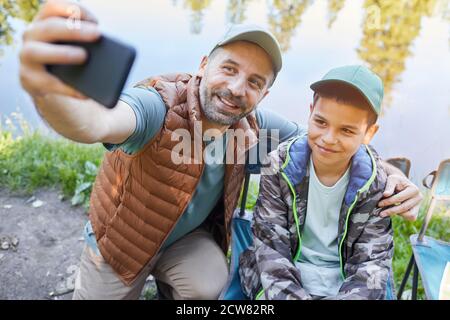 High angle portrait of loving father taking selfie photo with cute ...