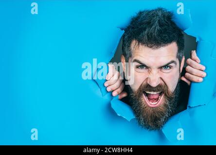 Male face through the hole in paper Stock Photo - Alamy