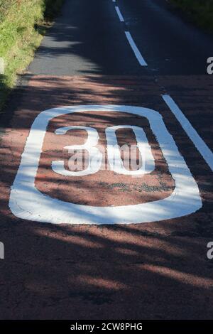 Road markings showing a 20 mph speed limit at the approach to a ...