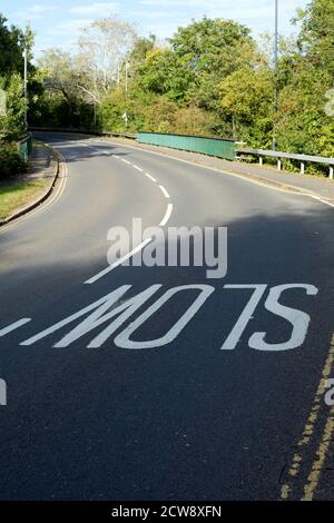 Slow down road marking Stock Photo - Alamy