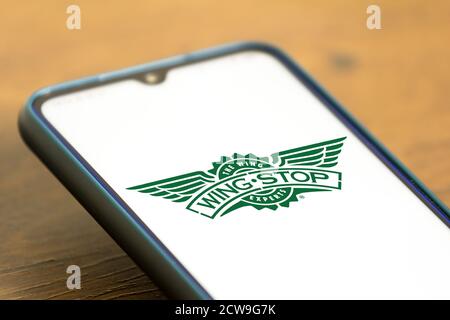 In this photo illustration a Wingstop logo of an US chain of ...