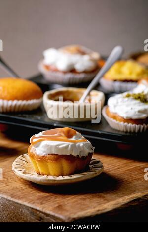 Fresh baked delicious different cupcakes served together with wood ...