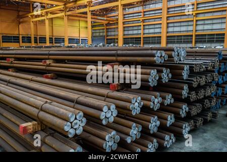 Steel round bar storage and stacking in a warehouse Stock Photo - Alamy