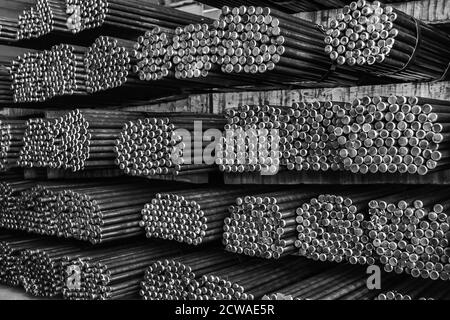 Steel round bar storage and stacking in a warehouse Stock Photo - Alamy
