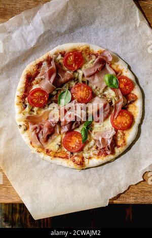 Homemade pizza on baking paper isolated on white Stock Photo - Alamy