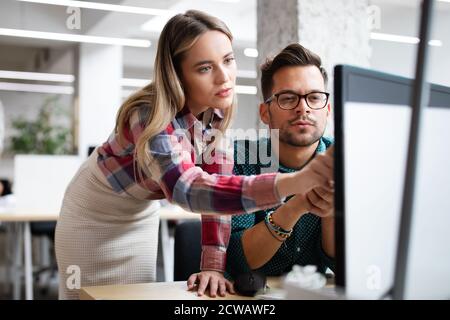 Company employees working in software development Stock Photo - Alamy