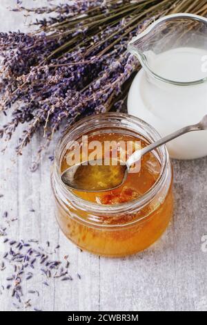 Glass of honey, honeycomb and lavender flowers Stock Photo - Alamy