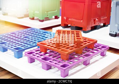 Plastic colored pallets at the trade show Stock Photo - Alamy