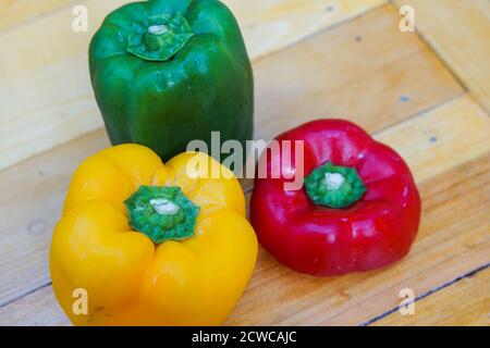 Colorful capsicum on wooden table background Stock Photo - Alamy
