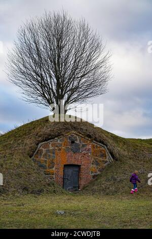 House or bunker built of stone underground with solid wood door and ...
