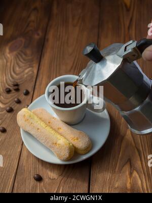 Pouring coffee out of italian coffee pot Stock Photo - Alamy
