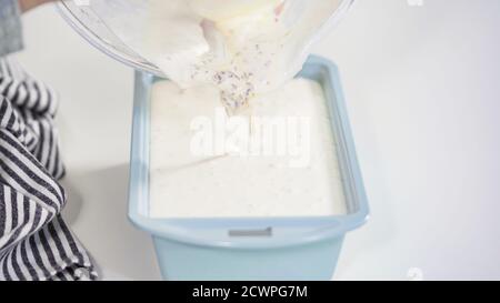 Pouring ice cream mixture into the baking pan to be frozen Stock Photo ...