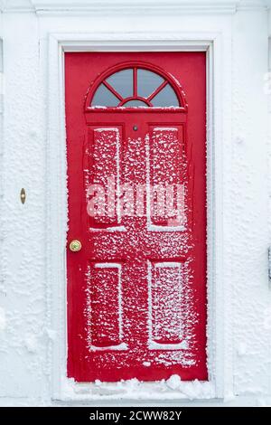 The white front door is covered with snow after a blizzard Stock Photo ...