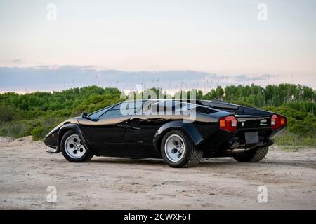 Rear 3/4 view of a 1985 Lamborghini Countach 5000QV with the doors open ...