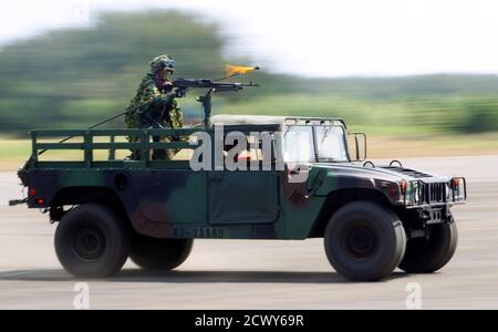 An M998 High-Mobility Multipurpose Wheeled Vehicle (HMMWV) carrying a ...