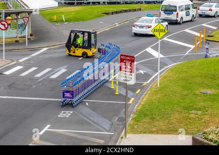 Auckland, New Zealand: A baggage cart mover is returning stray baggage ...