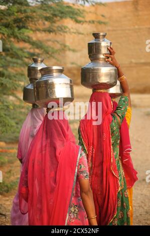 rural women collecting water from village well at Dhakne village, Shahapur Thane Maharashtra ...