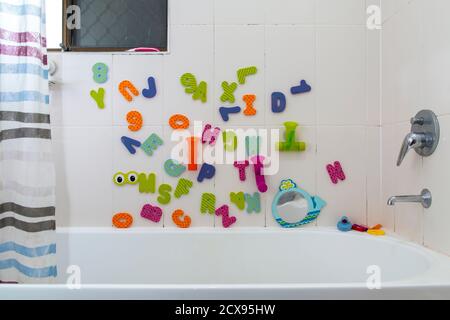 Childs alphabet bath toys in bathroom Stock Photo - Alamy